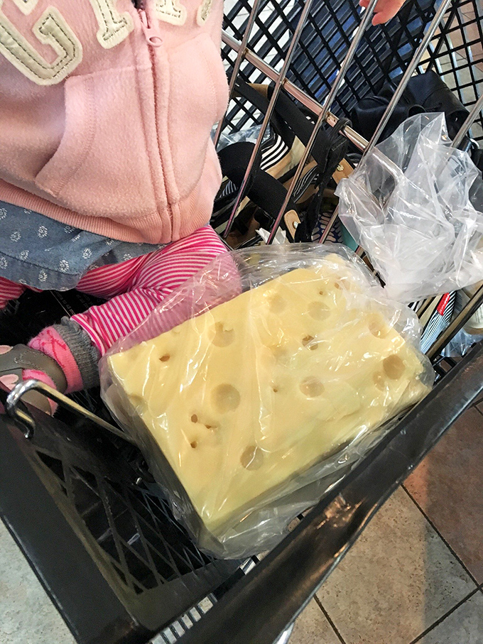 Wheels of cheese stacked like edible architecture, each one representing generations of dairy expertise and delicious tradition you can slice.