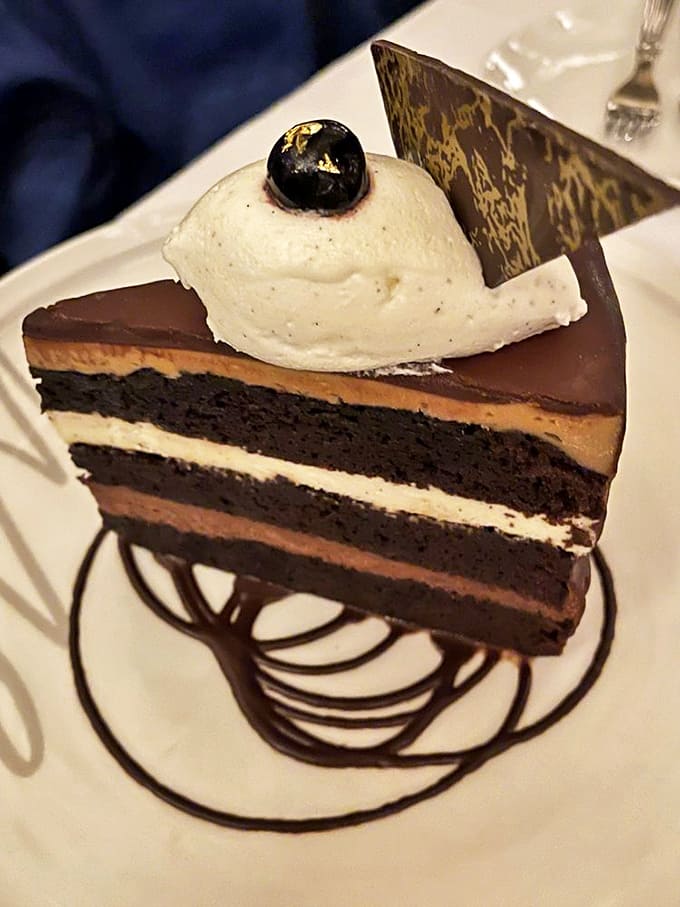 Layers of chocolate decadence separated by creamy filling &ndash; this cake doesn't just satisfy your sweet tooth, it throws it a surprise party.