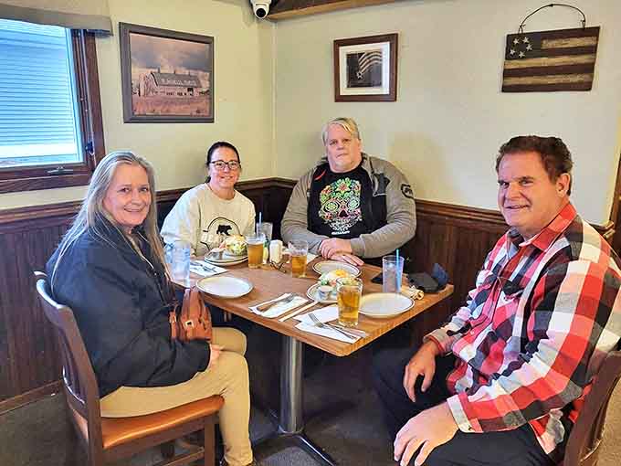 Happy diners sharing stories and slices &ndash; the true measure of a great pizza joint isn't just the food, but the memories made around it.