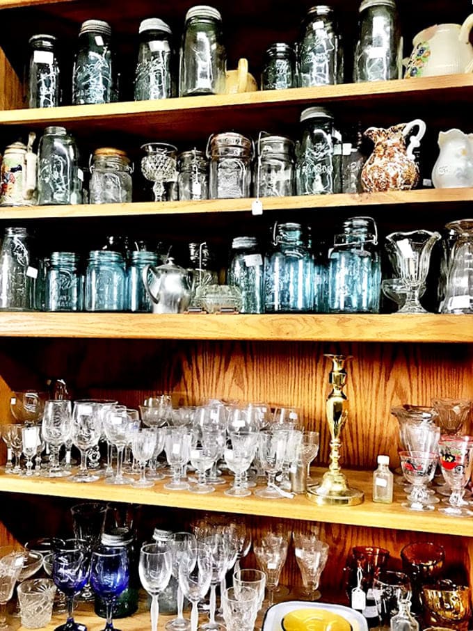 Mason jars, Depression glass, and delicate stemware – this collection spans from practical preservation to elegant entertaining across generations.