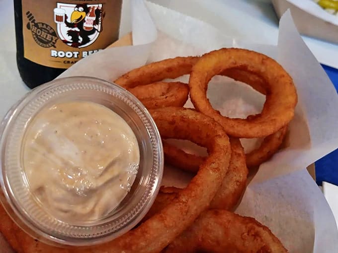 These aren't just any onion rings &ndash; they're golden halos of crispy perfection with a side of house sauce that elevates the humble onion to something worth celebrating.