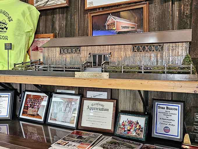 Awards and memorabilia cover the walls like a scrapbook of deliciousness, each frame telling stories of satisfied customers and local love.
