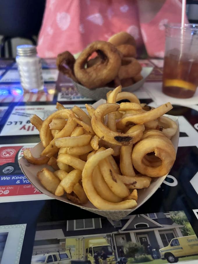 Curly fries and onion rings that could make a vegan question their life choices &ndash; golden, crispy, and utterly irresistible.