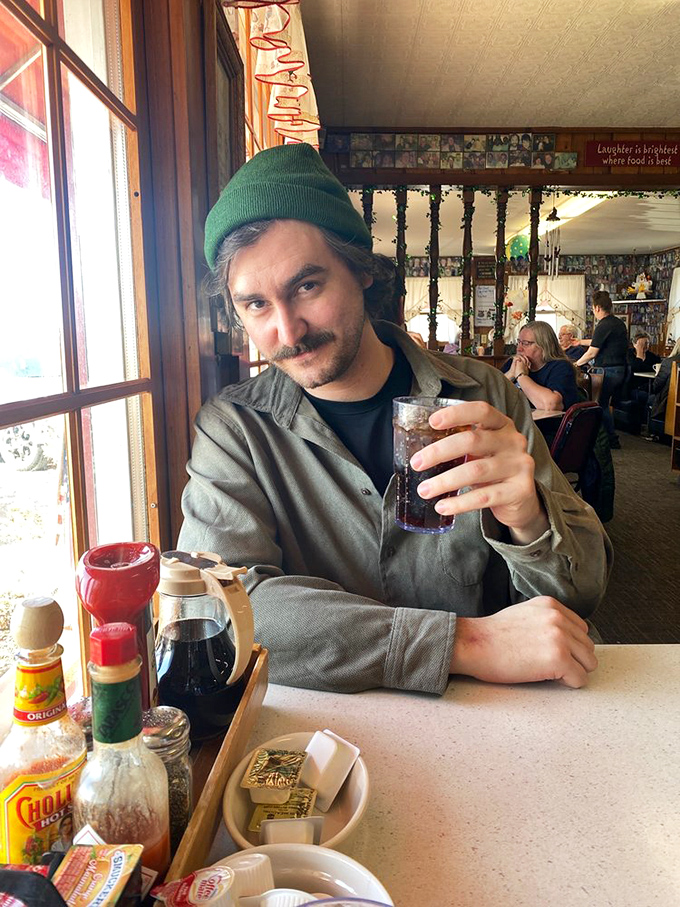 A patron enjoying the simple pleasure of a cold drink in a place where everybody feels like a regular.