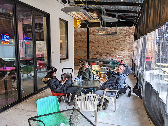 Diners enjoying the covered patio area, where conversations flow as freely as the mustard on a Chicago dog.