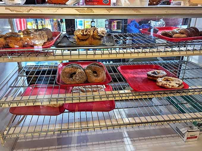 The display case &ndash; a treasure chest of pastry delights where decisions become impossible and "I'll take one of each" seems entirely reasonable.