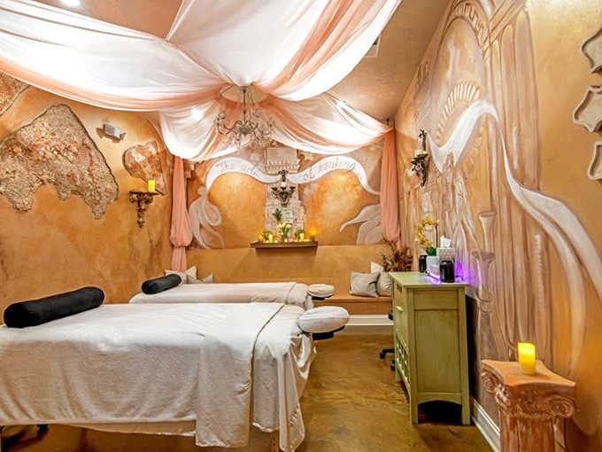 Romance meets wellness in this dreamy couples' treatment space where soft fabrics and golden hues create the perfect backdrop for side-by-side pampering.