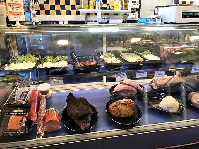 A rainbow of deli salads and premium meats awaits behind glass, each one prepared with recipes passed down through generations.