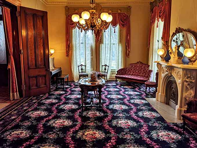 The formal reception room, where important guests were entertained, features a fireplace mantel that's basically the Victorian version of a humble brag.
