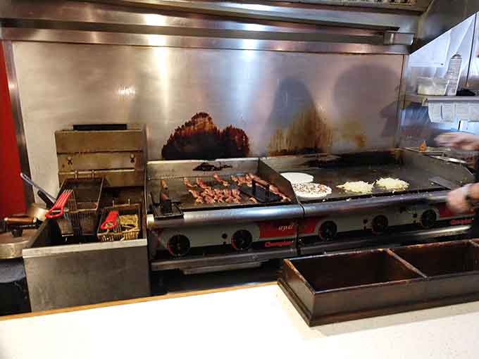 Watch your breakfast come to life on this well-seasoned griddle, where hash browns achieve their ultimate crispy destiny.