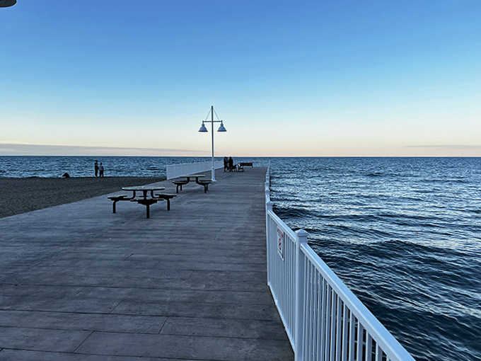 The pier stretches toward the horizon like an invitation to adventure, offering walkers the magical sensation of being surrounded by water.