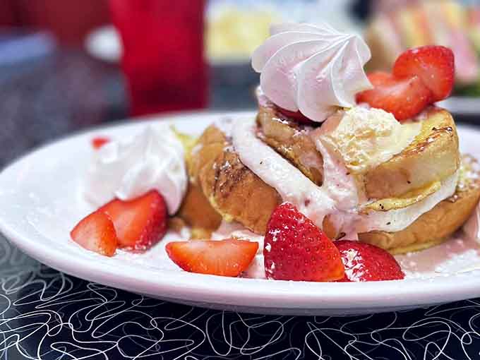 French toast transformed into dessert for breakfast &ndash; fresh strawberries, whipped cream, and enough decadence to make Monday bearable.