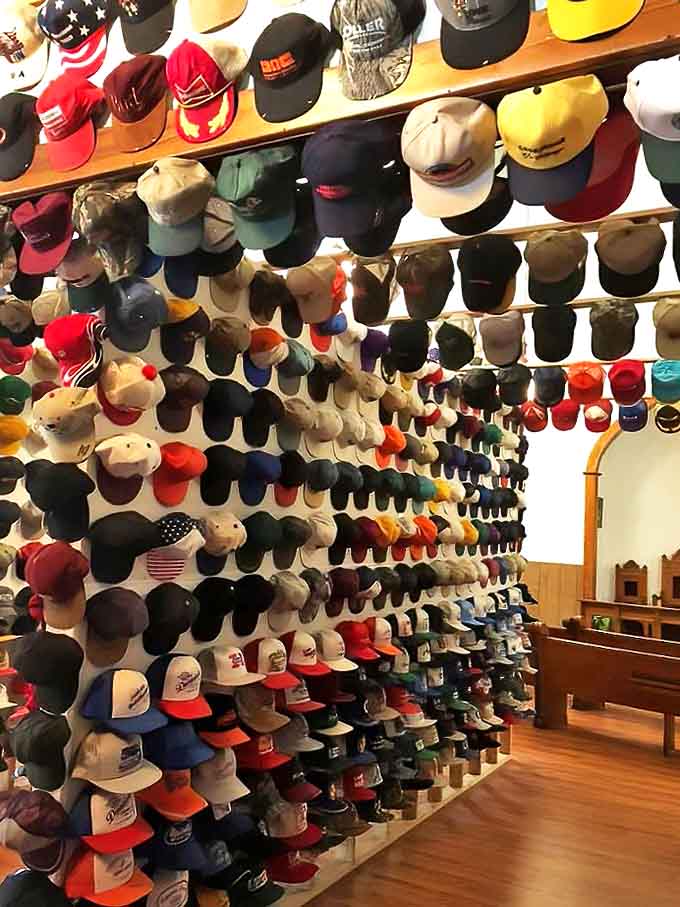The collection climbs toward heaven, with hats stacked so high they seem to reach for the former church's celestial ceiling.