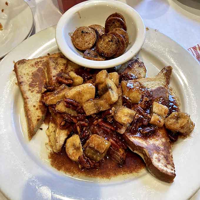 Bananas Foster French toast that's basically dessert masquerading as breakfast &ndash; caramelized bananas and buttery rum sauce creating morning magic.