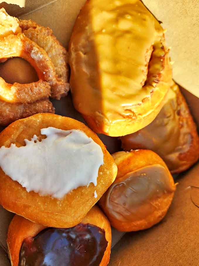 These aren't just donuts—they're pillowy clouds of fried perfection that make you understand why police officers risk their lives daily.