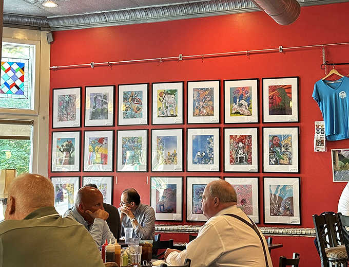 Artwork lines the crimson walls, transforming a simple breakfast into a cultural experience that feeds both stomach and soul.