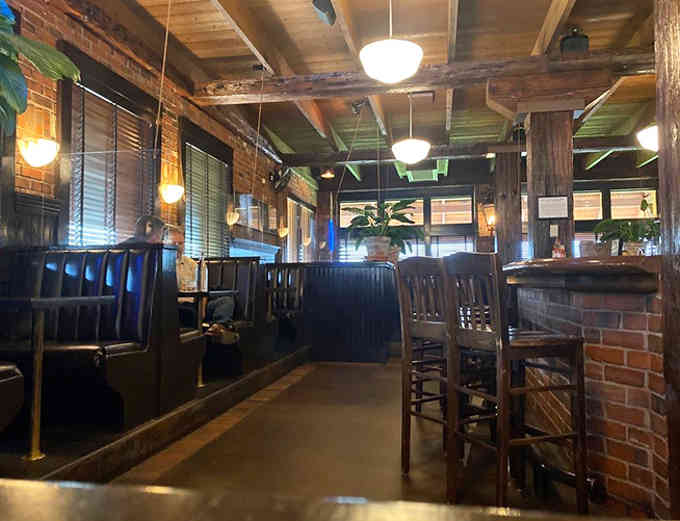 Wooden tables and chairs create an atmosphere of rustic elegance, where white tablecloths meet weathered beams in perfect harmony.