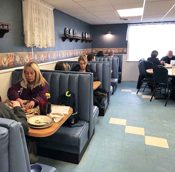 The dining room hums with conversation and satisfaction &ndash; these blue booths have witnessed countless happy meals.