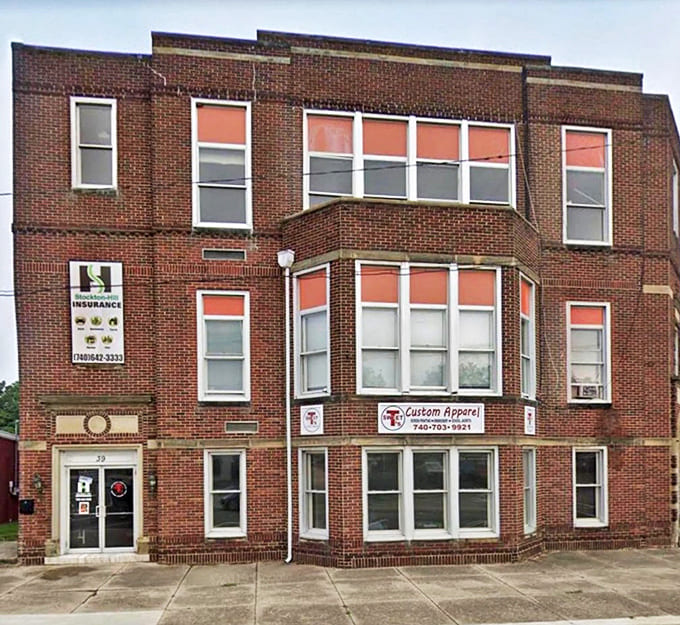 This brick building has witnessed generations of Kingston history, its windows reflecting both past and present without judgment.