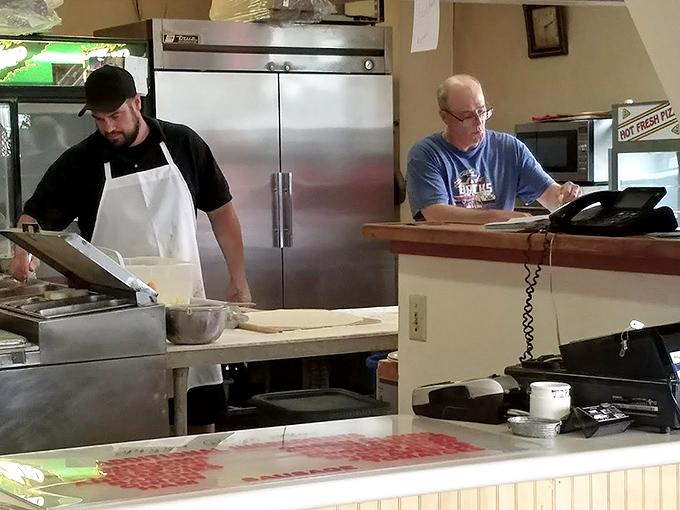 Behind-the-scenes magic: where pizza artisans transform simple ingredients into the comfort food equivalent of a warm hug on a cold day.