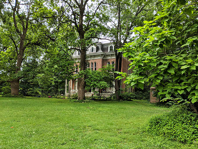 Lush green grass surrounds the historic home, providing a deceptively peaceful setting for one of America's most actively haunted locations.