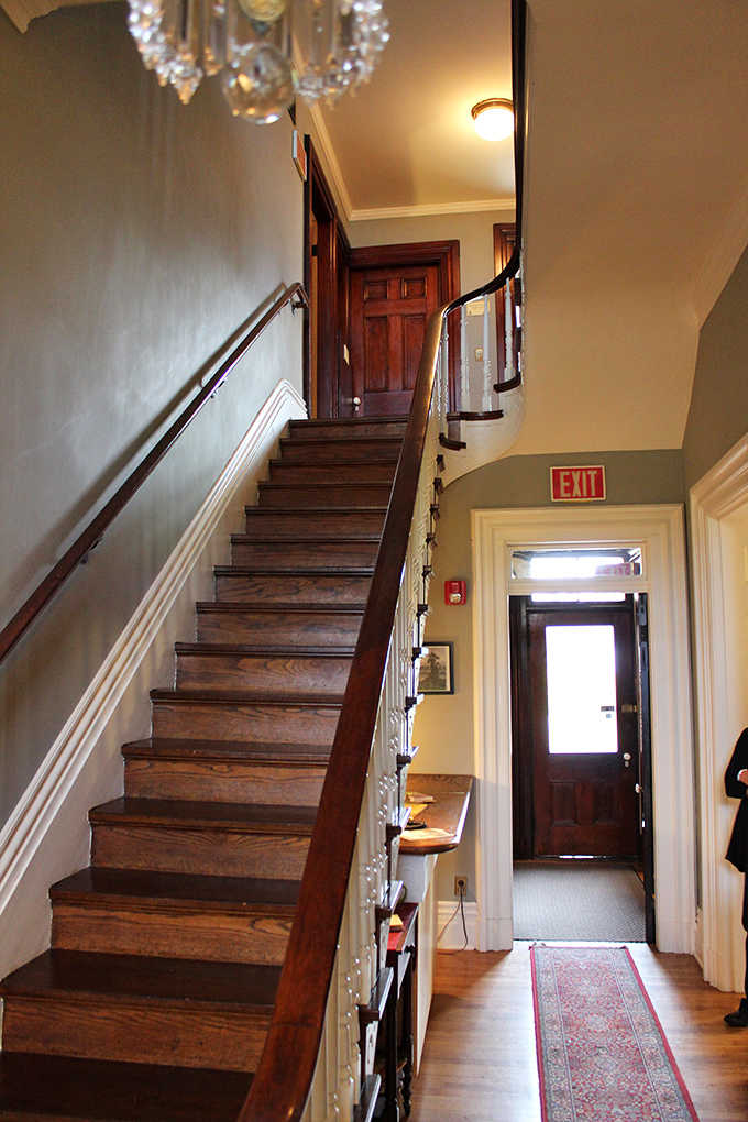 This staircase has witnessed over a century of comings and goings, each step worn with the passage of countless feet and untold stories.