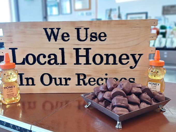 "We Use Local Honey In Our Recipes" &ndash; a simple wooden sign that speaks volumes about Wittich's commitment to quality ingredients and supporting the community.