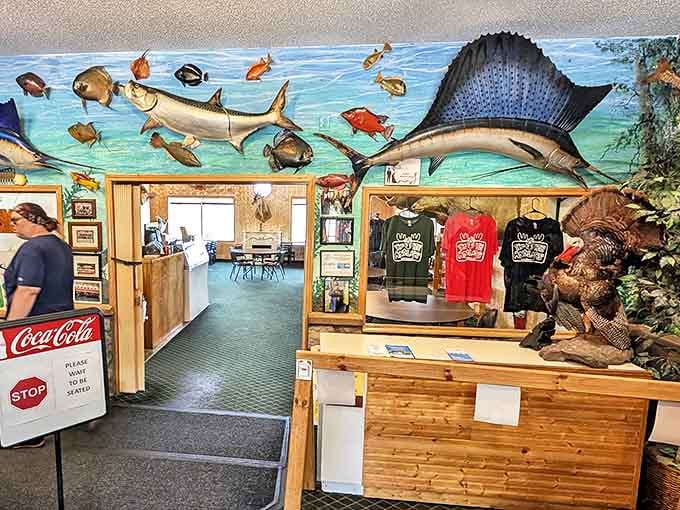 The entrance area doubles as a souvenir shop, where colorful fish mounts swim across the walls and branded merchandise lets you take the Antlers experience home.