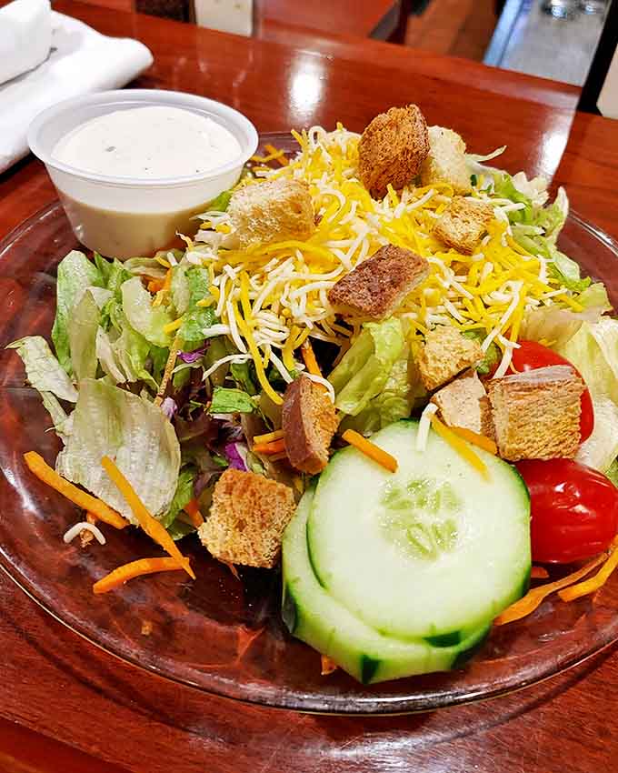 A rainbow of fresh vegetables and shredded cheese creates a garden on your plate, proving salads don't have to be boring.