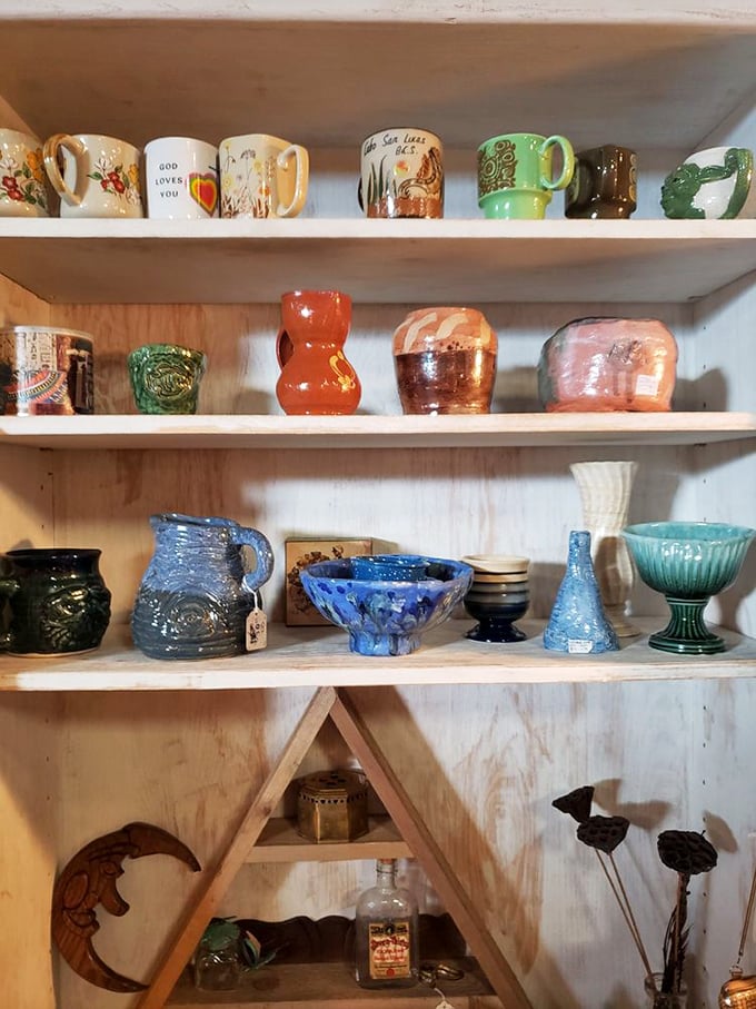 Vintage mugs and pottery line rustic shelves, each piece with its own personality – from kitschy souvenirs to handcrafted artisan pieces.