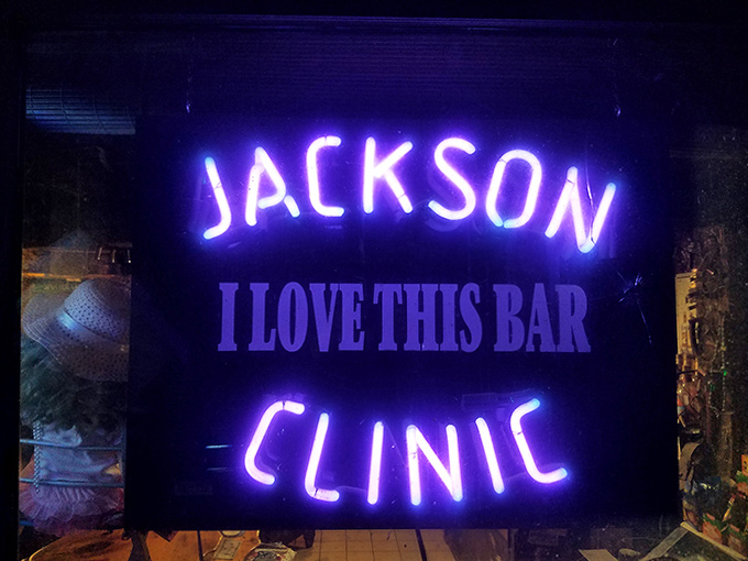 The neon "JACKSON CLINIC" sign promises the best kind of therapy &ndash; cold drinks and warm conversation.