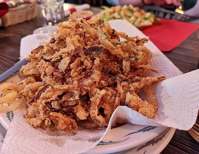 These aren't just any onion rings &ndash; they're hand-breaded, crispy golden halos that shatter delicately with each bite, revealing sweet onion within.