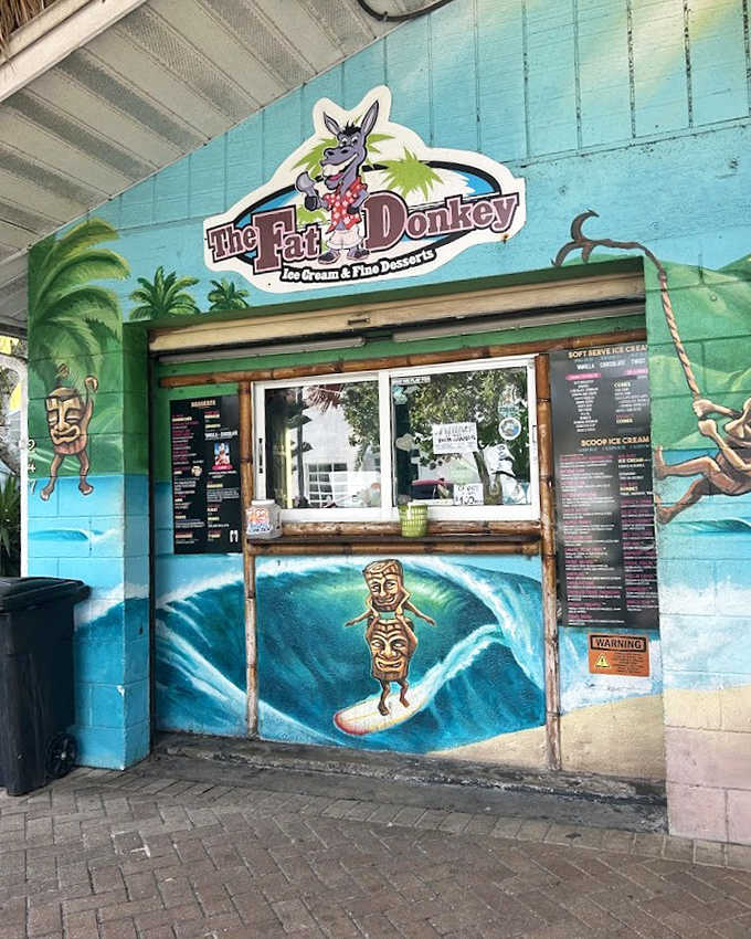 The ordering window, where dreams come true and diets go to die. Surfing tiki gods and tropical murals set the stage for serious flavor decisions.