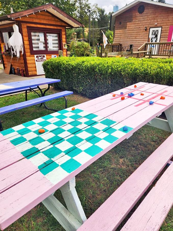 Outdoor picnic tables with painted checkerboards invite guests to linger after their meal and enjoy the peaceful Hocking Hills setting.