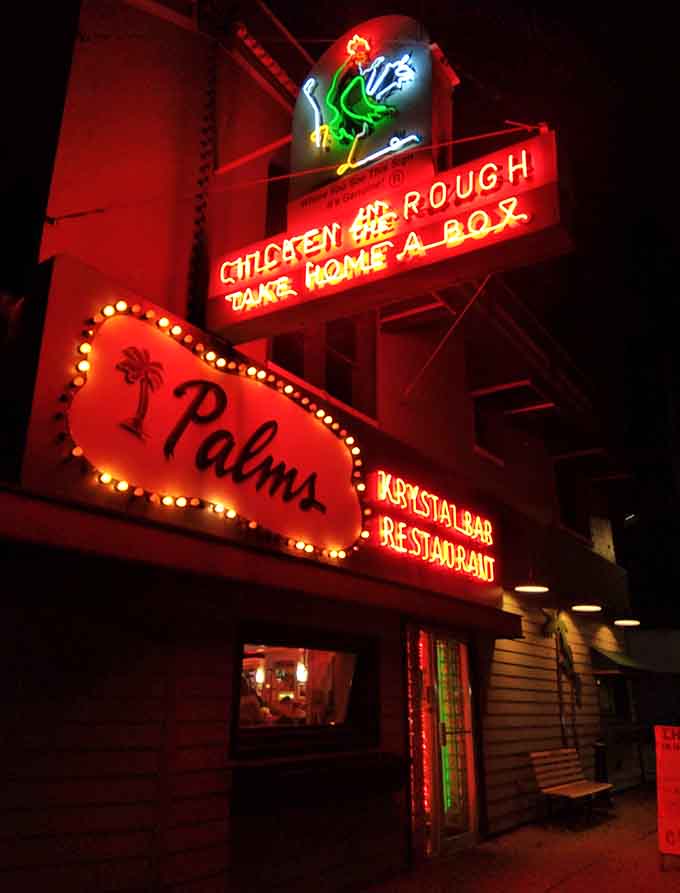 Multi-generational dining at its finest &ndash; where families gather in red booths to share meals and memories without smartphone distractions.