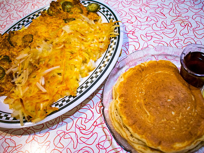 A hearty breakfast spread featuring a cheese-loaded omelet and golden pancakes &ndash; the fuel that powers Wisconsin's hardworking folks.