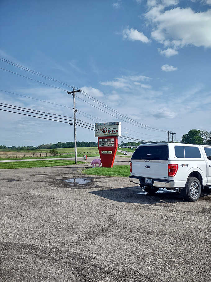 The parking lot view reveals Bill's strategic roadside location, with the iconic sign promising barbecue bliss to passing travelers.