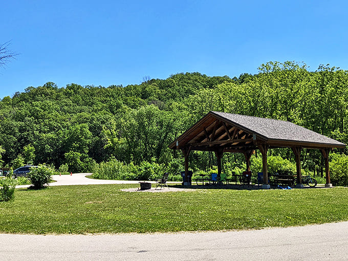 The rustic pavilion offers welcome shade for summer picnickers, its limestone construction echoing the park's natural geological features.