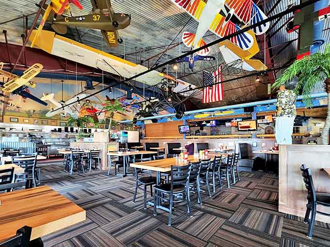 Tables spaced for conversation rather than eavesdropping, with overhead planes creating natural conversation starters for first dates or family dinners.