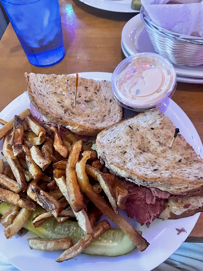 The Reuben sandwich arrives as a monument to excess &ndash; layers of corned beef, Swiss cheese, and sauerkraut creating a tower of flavor that requires both hands and several napkins.