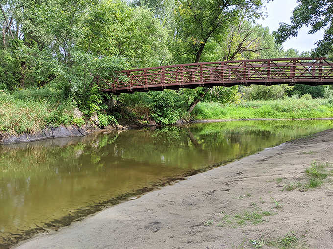 A rustic bridge spans the creek, offering both passage and pause &ndash; the perfect spot for contemplating life at nature's pace.