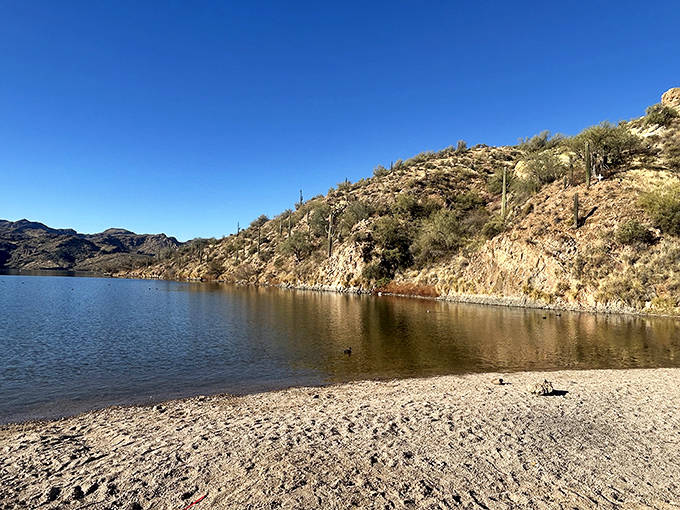 Saguaro Lake's pristine waters reflect the surrounding landscape, creating a double vision of Arizona's rugged beauty.