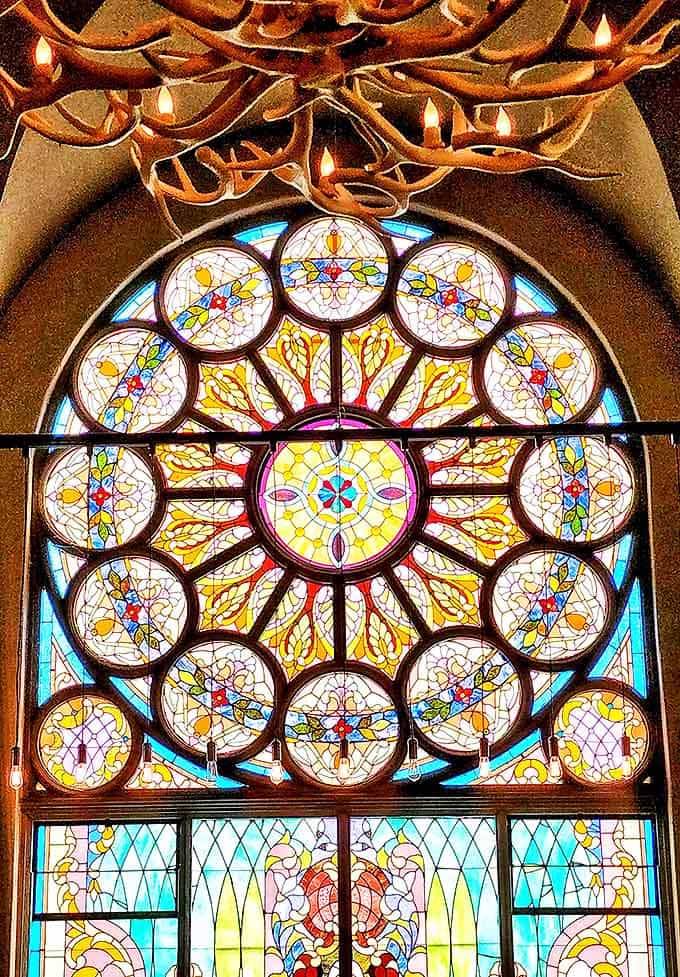 A masterpiece of stained glass creates a kaleidoscope of colors, turning an ordinary beer into a transcendent experience.