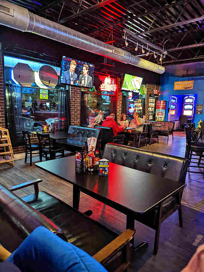 Cozy booths, ambient lighting, and exposed ductwork create that perfect "industrial chic meets neighborhood hangout" vibe.