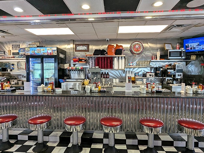 The service counter gleams with promise, a stainless steel stage where breakfast dreams come true under the watchful eye of the StarLite clock.