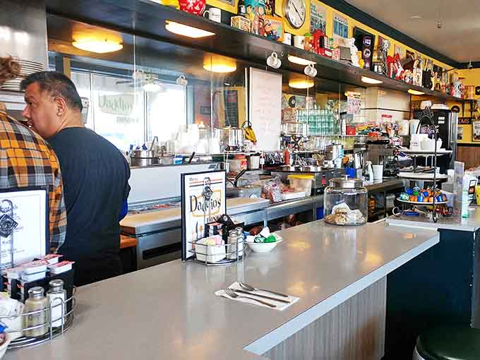 Command central for coffee refills and friendly banter, where regulars perch for prime viewing of short-order cooking choreography.