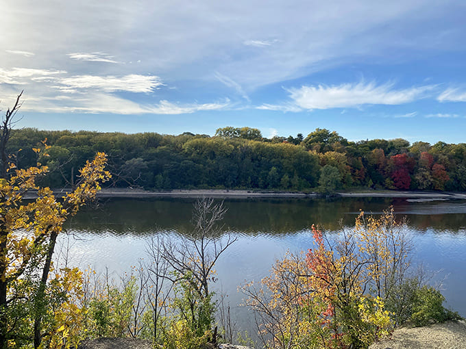 The Mississippi River stretches majestically below the trail, a reminder of the greater watershed that Shadow Falls feeds.