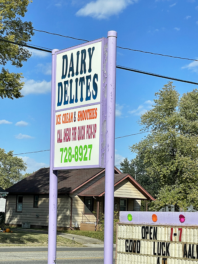 Signage: The purple beacon of Dairy Delites stands tall, promising cold comfort and sending encouraging messages to passing teams.
