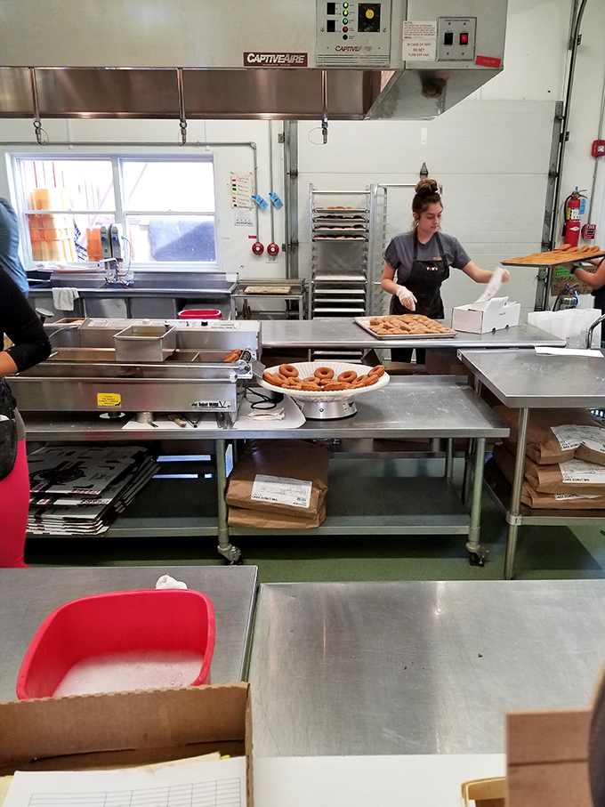 Behind the scenes, skilled hands craft those legendary donuts, each one destined for greatness and a very brief existence before being devoured.