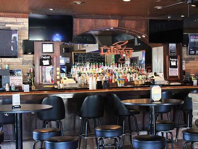 The heart of The Library Bar &ndash; where bottles stand like colorful book spines and every drink order begins a new chapter.